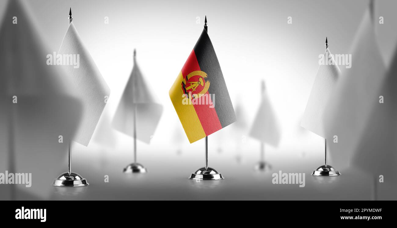 The national flag of the GDR surrounded by white flags Stock Photo - Alamy