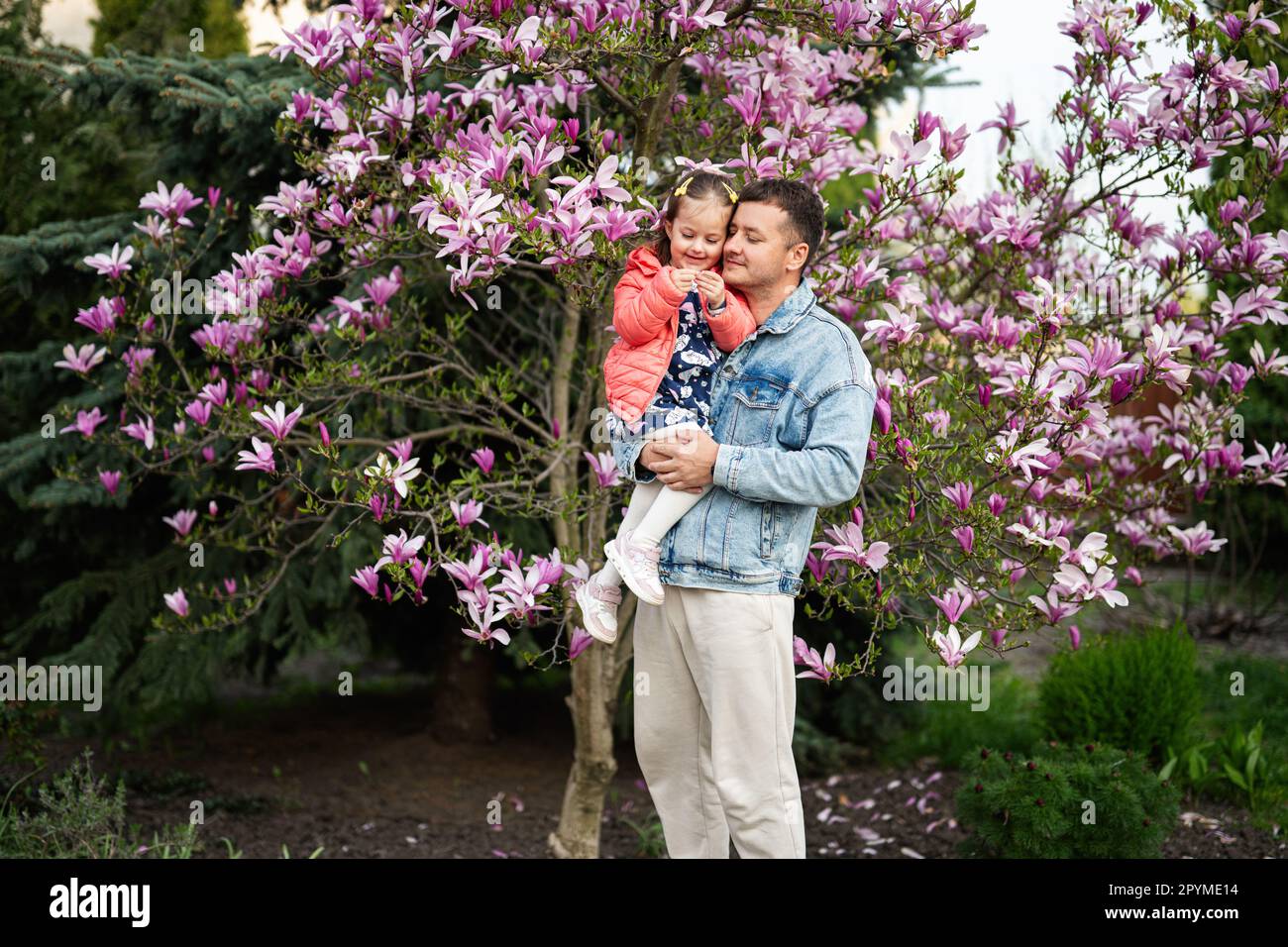 Happy Father's Day. Father with daughter in hands enjoying nice spring ...