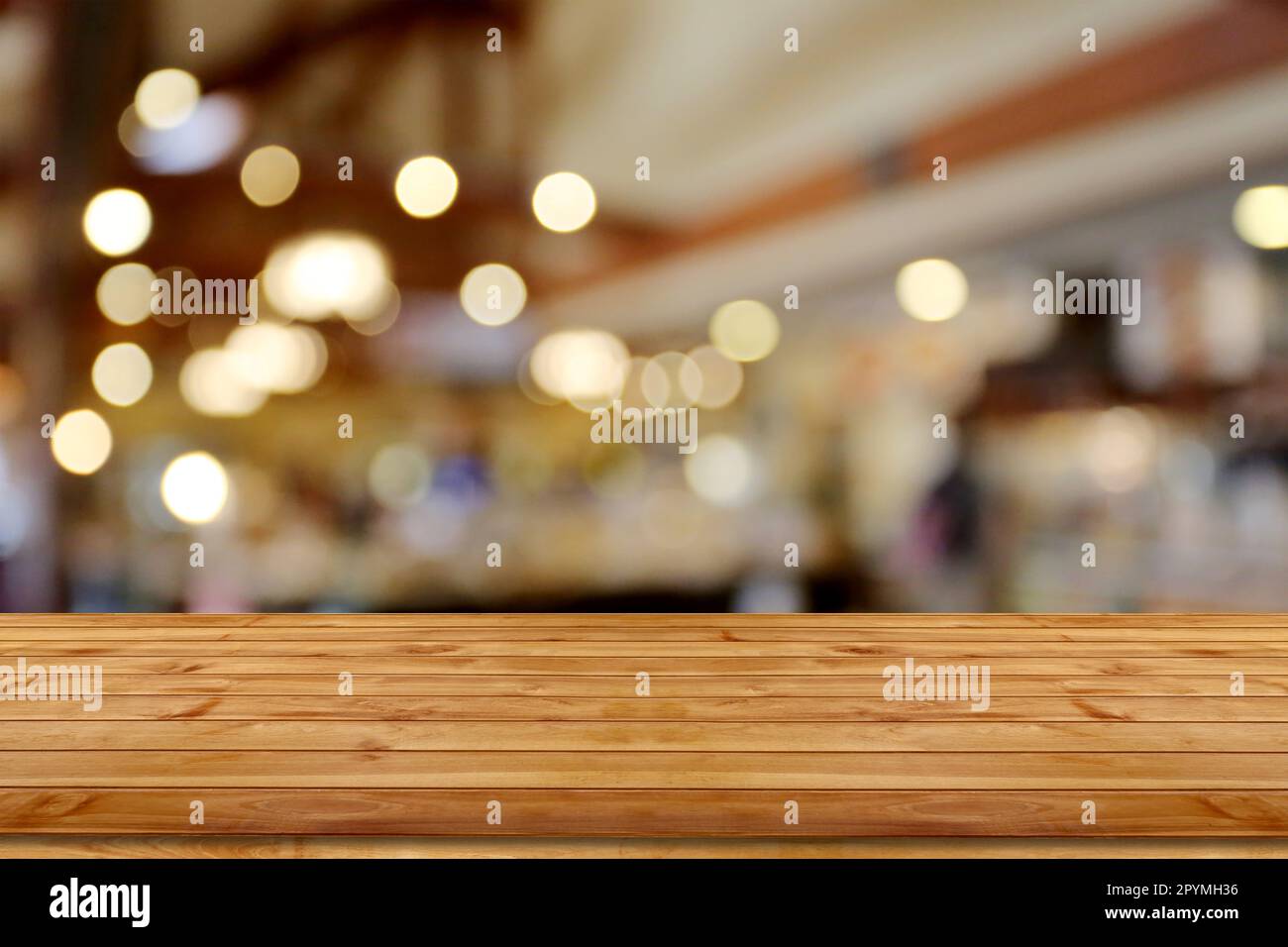 Floor of an empty wooden table with a backdrop of restaurant bokeh ...