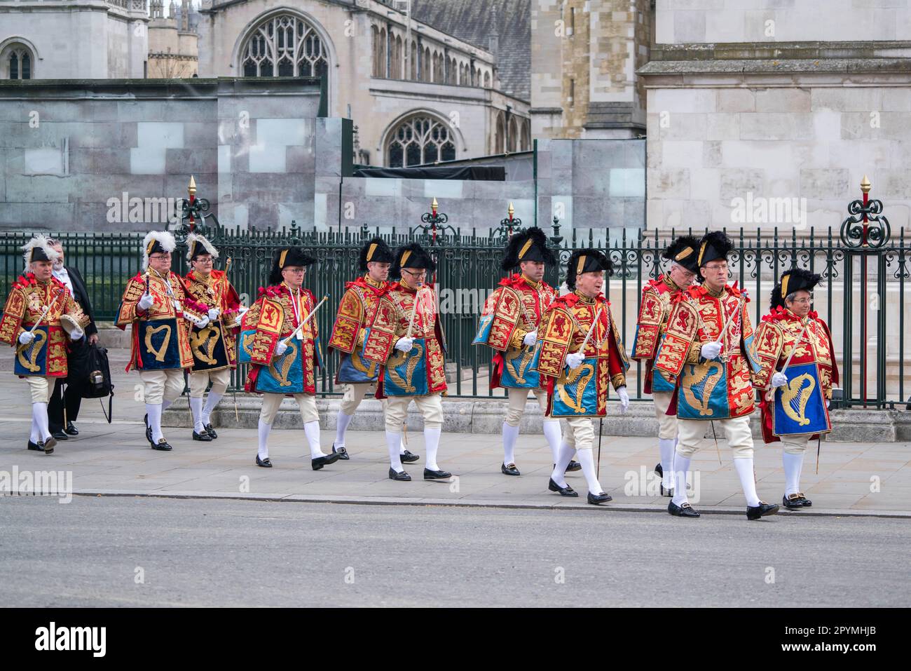 London UK. 4 May 2023. Heraldic Kings of Arms walk past the entrance to ...