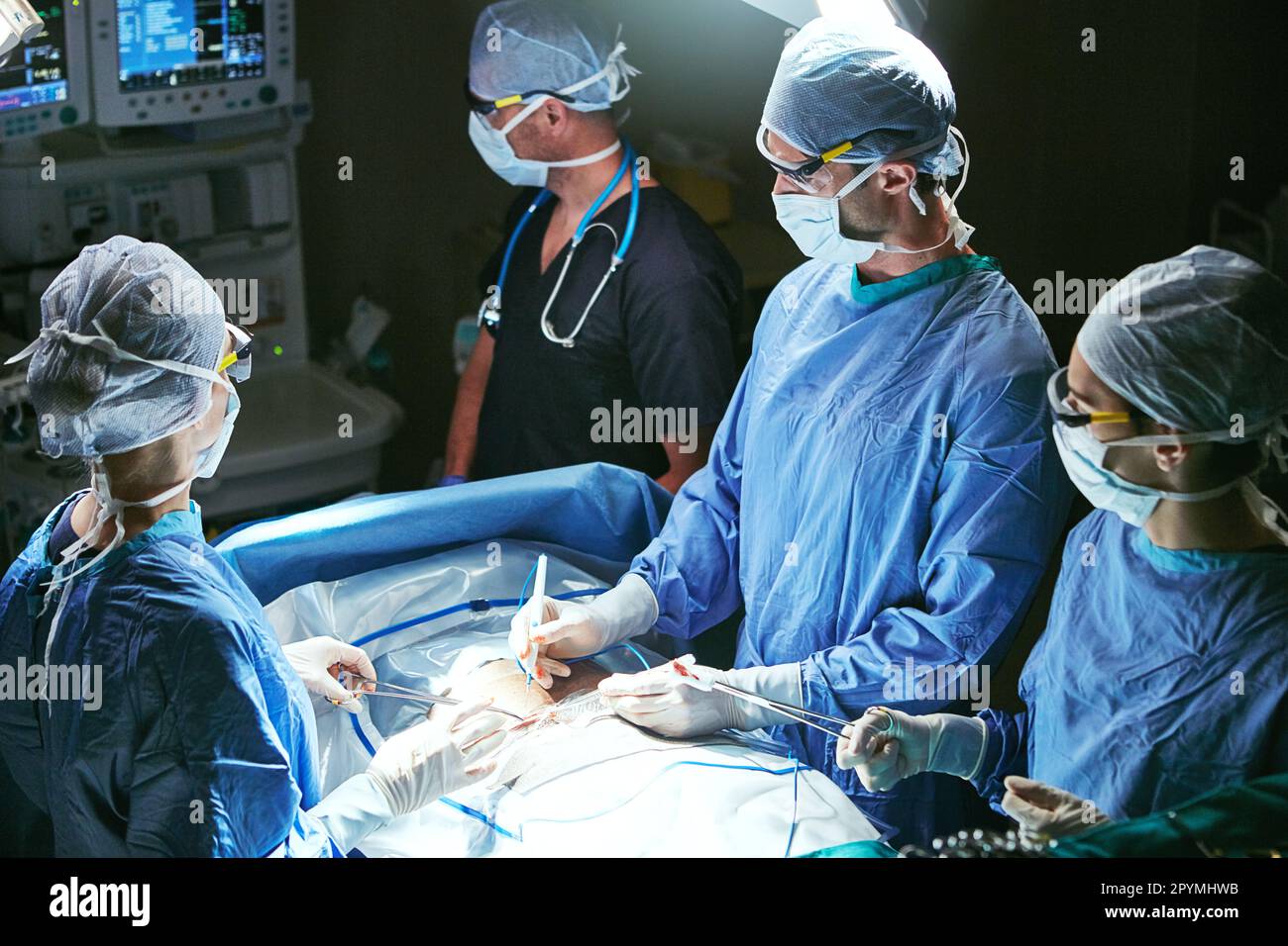 Saving lives is the job description. surgeons in an operating room ...