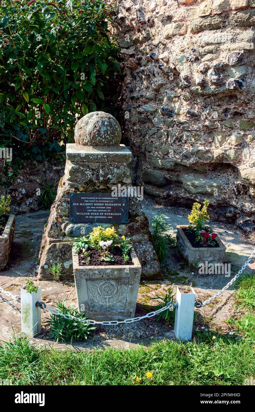 A pyramidal stone memorial capped by round stone and bearing a bronze ...