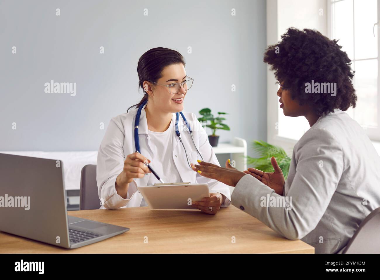 Doctor holding report file with appointment and giving consultation to ...