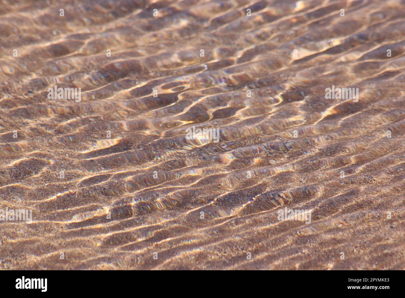 Ripples in sea water on beach Stock Photo - Alamy