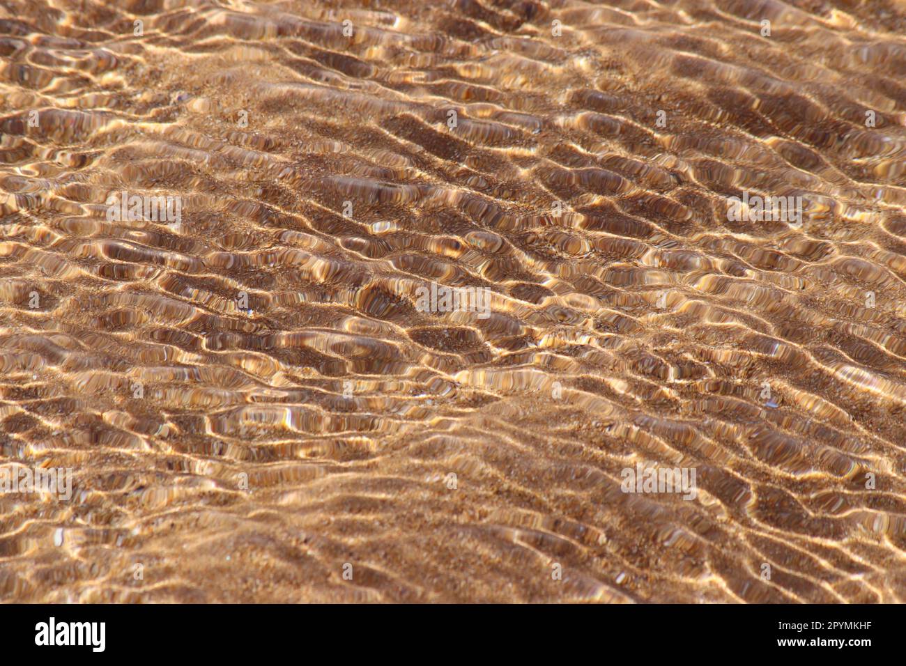 Ripples in sea water on beach Stock Photo - Alamy