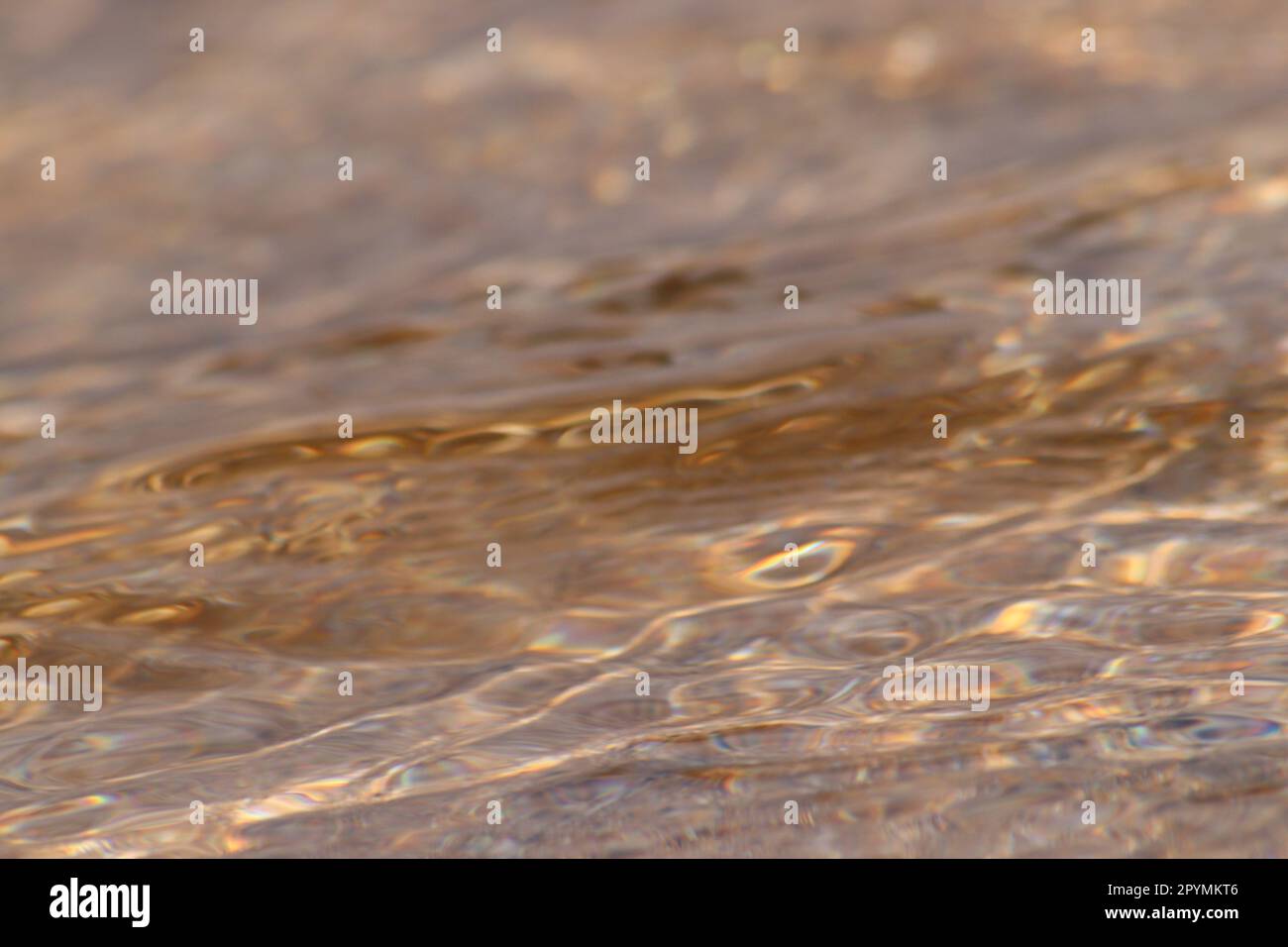 Ripples in sea water on beach Stock Photo - Alamy