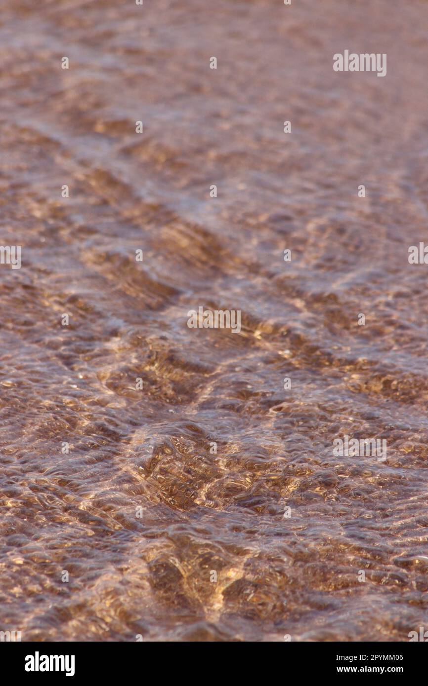 Ripples in sea water on beach Stock Photo - Alamy