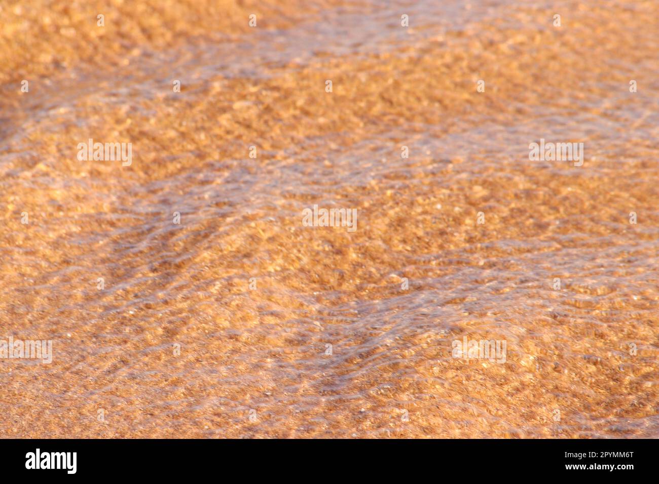 Ripples in sea water on beach Stock Photo - Alamy