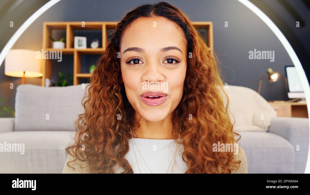 Influencer recording a video on a phone at home. Young woman live ...