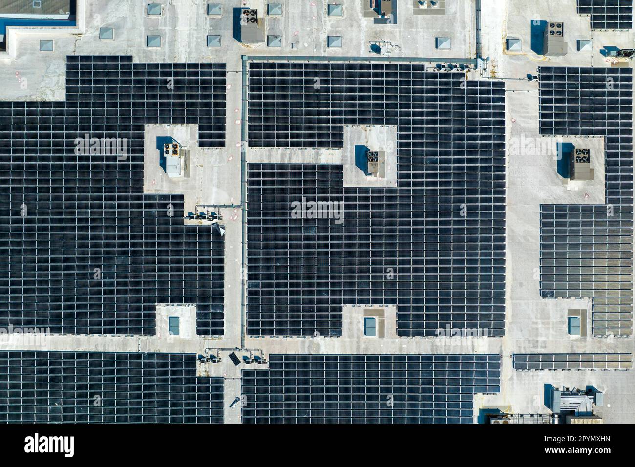 Aerial view of blue photovoltaic solar panels mounted on industrial ...
