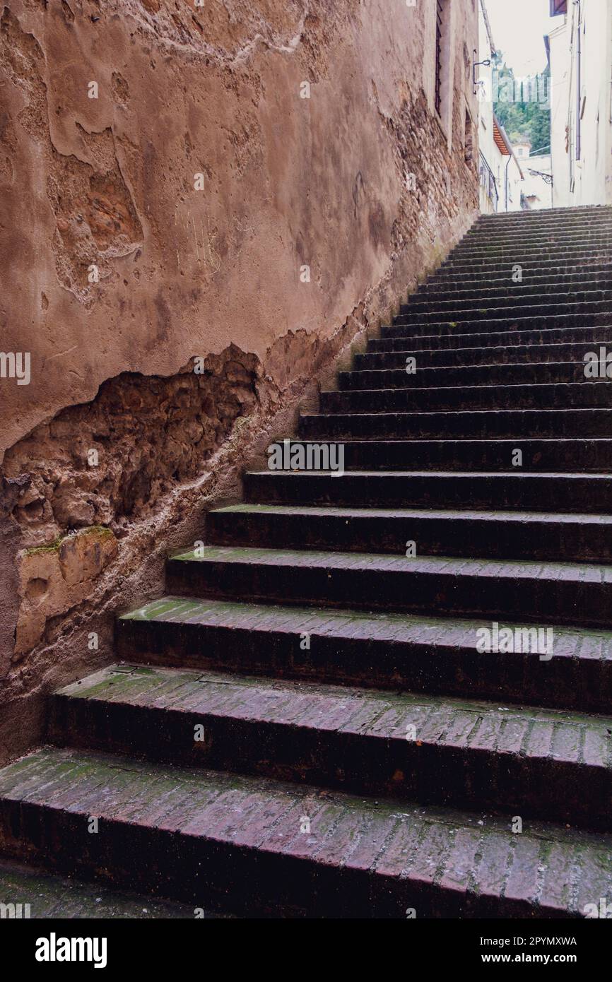 Old stone steps in a small Italian town, wethered and worn by passing ...