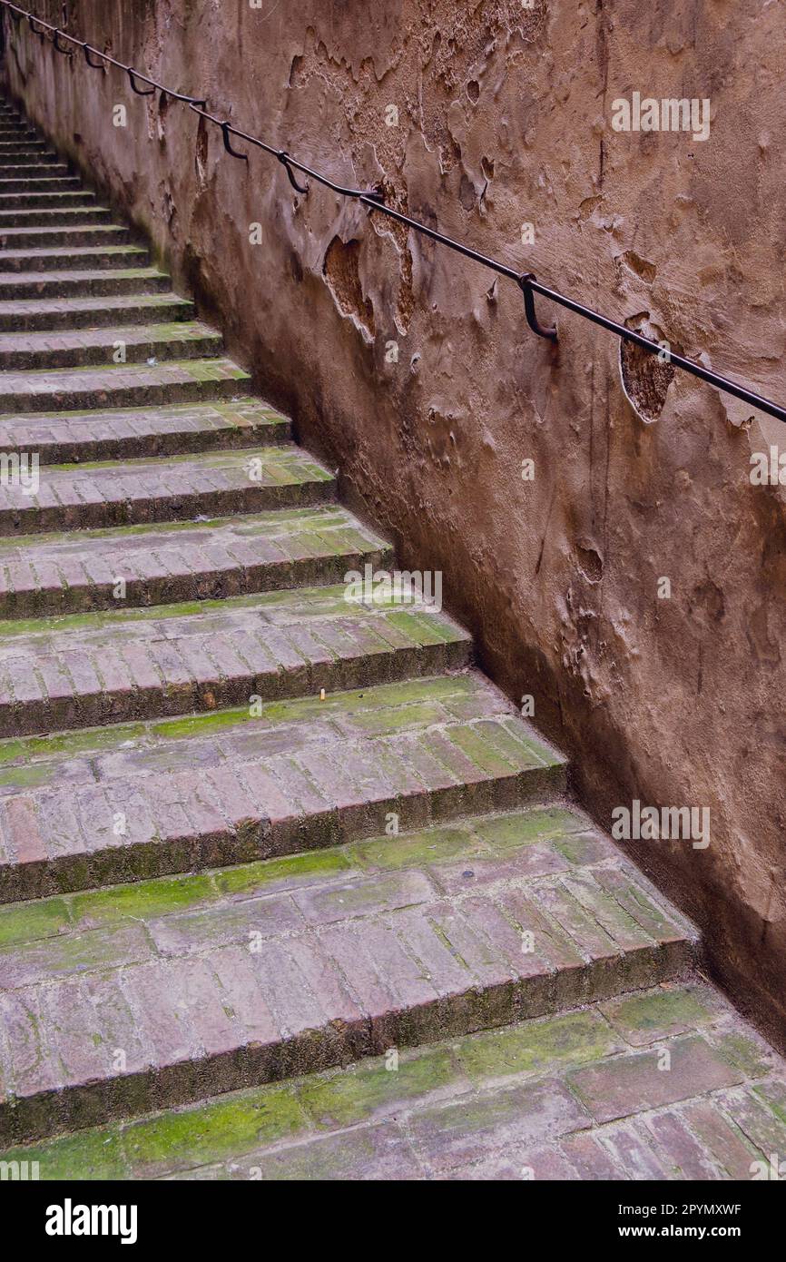 Old stone steps in a small Italian town, wethered and worn by passing ...