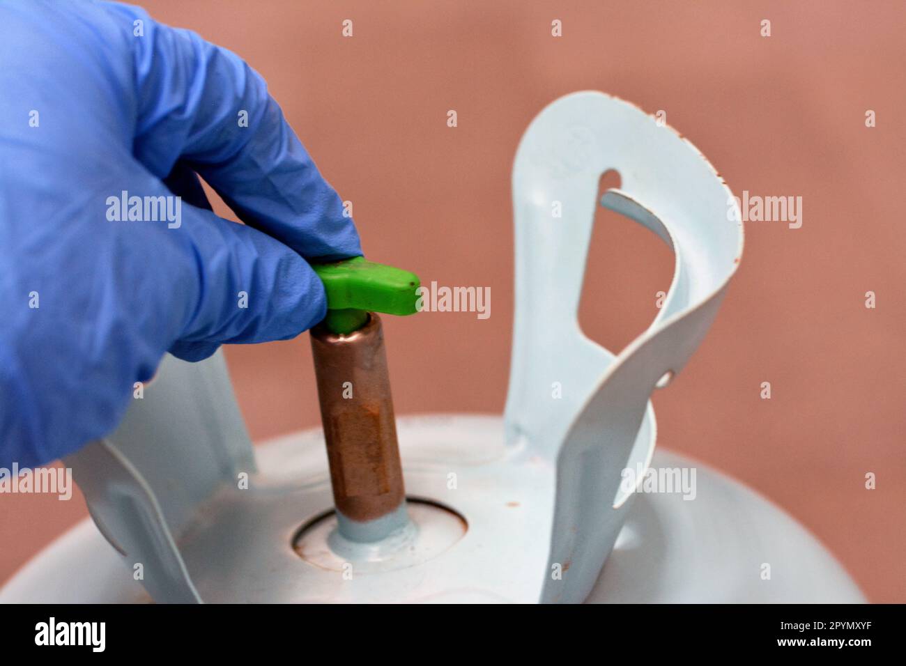A Freon gas cylinder filled with colorless gas at room temperature ...
