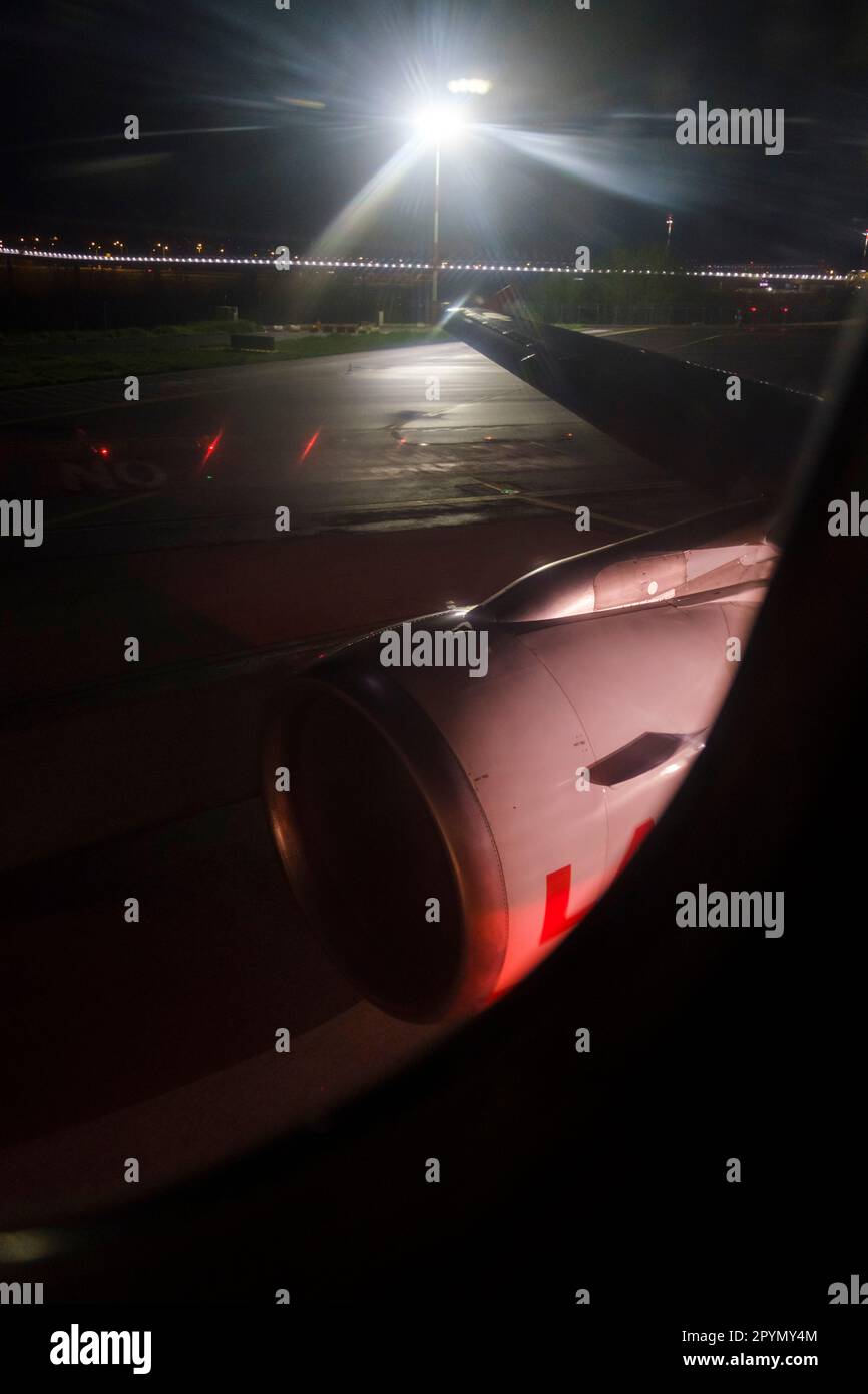 Looking out of an aeroplane window at night as it prepares for take off ...