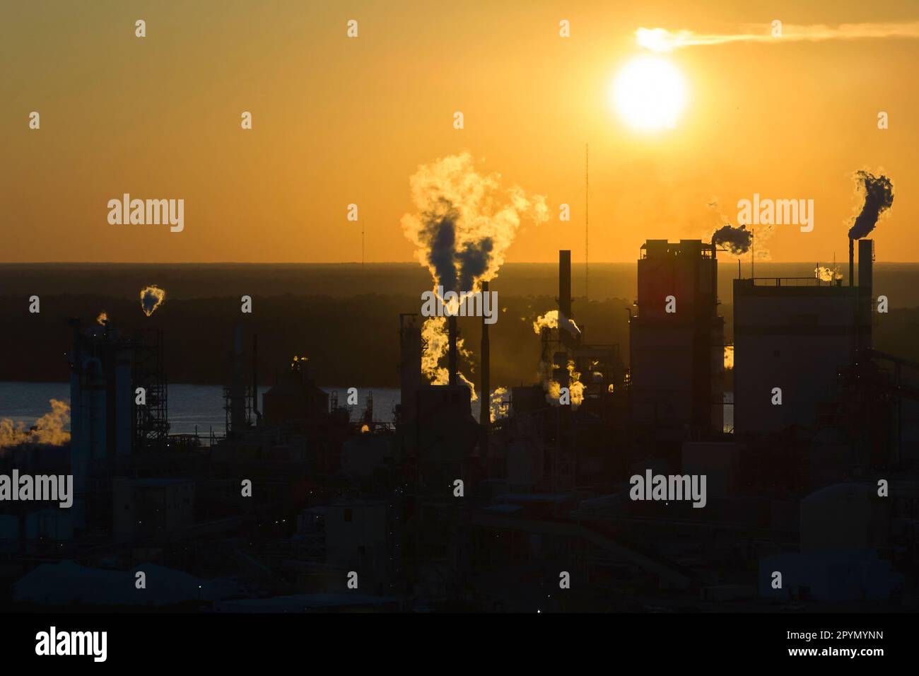 Aerial view of large factory with smokestack from production process ...