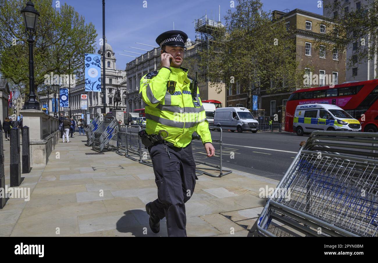 London, England, UK. Metropolitan Police officer talking on his mobile ...