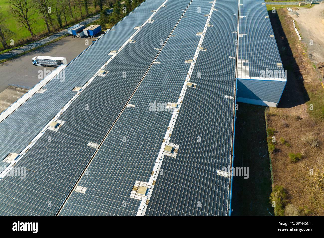 Aerial view of solar power plant with blue photovoltaic panels mounted ...