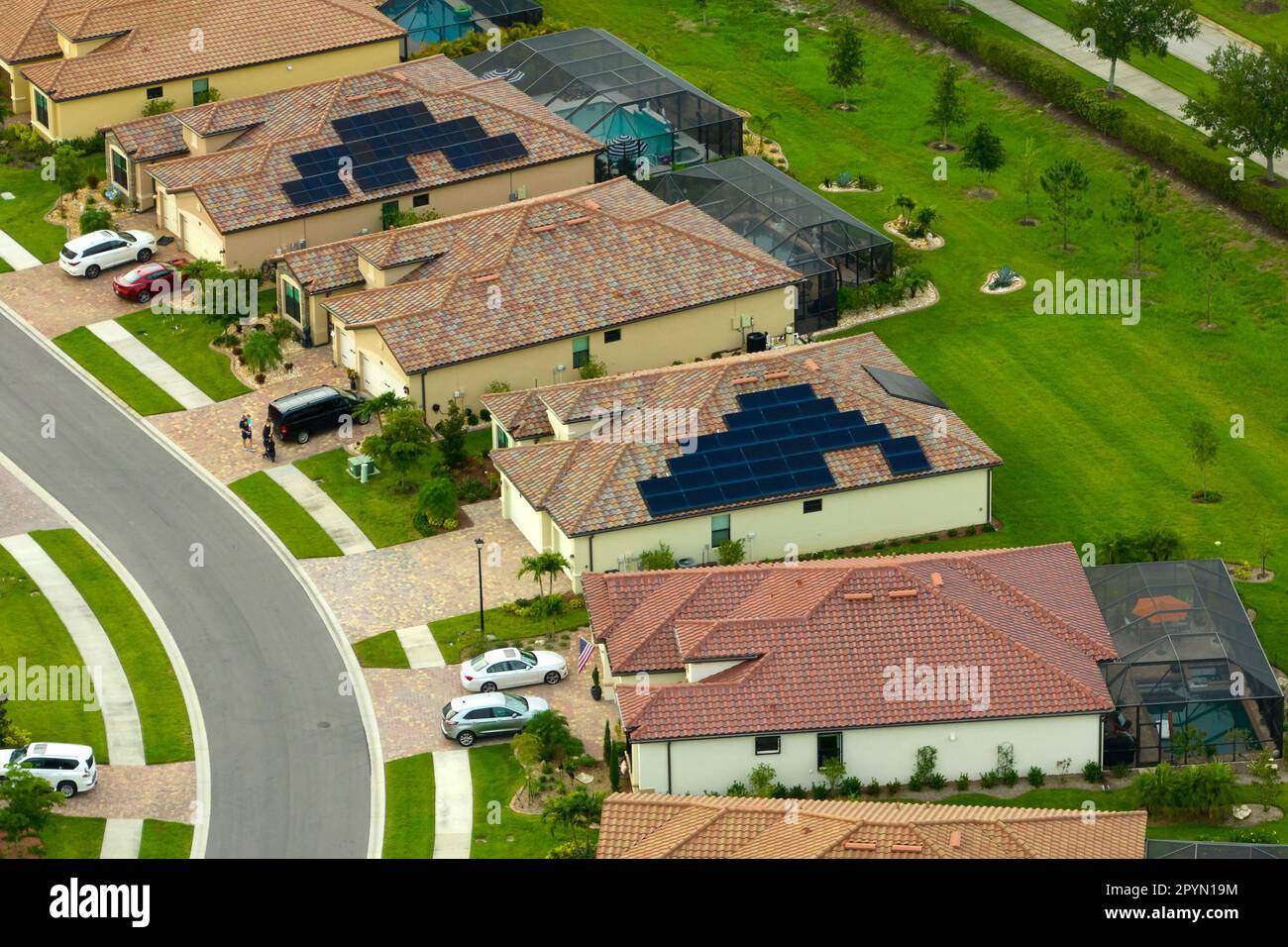 Aerial view of tightly located family houses with solar panels on roofs ...