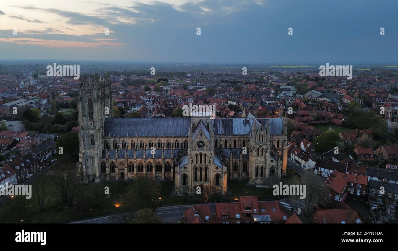 Aerial view of a grand cathedral at night, overlooking a sprawling ...