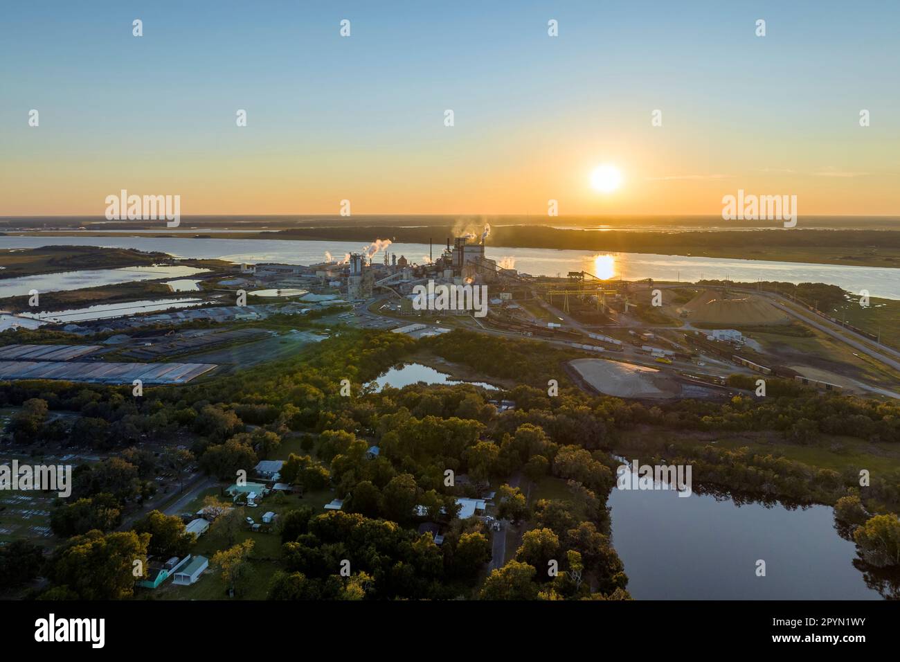 Aerial view of wood processing factory with smoke from production ...