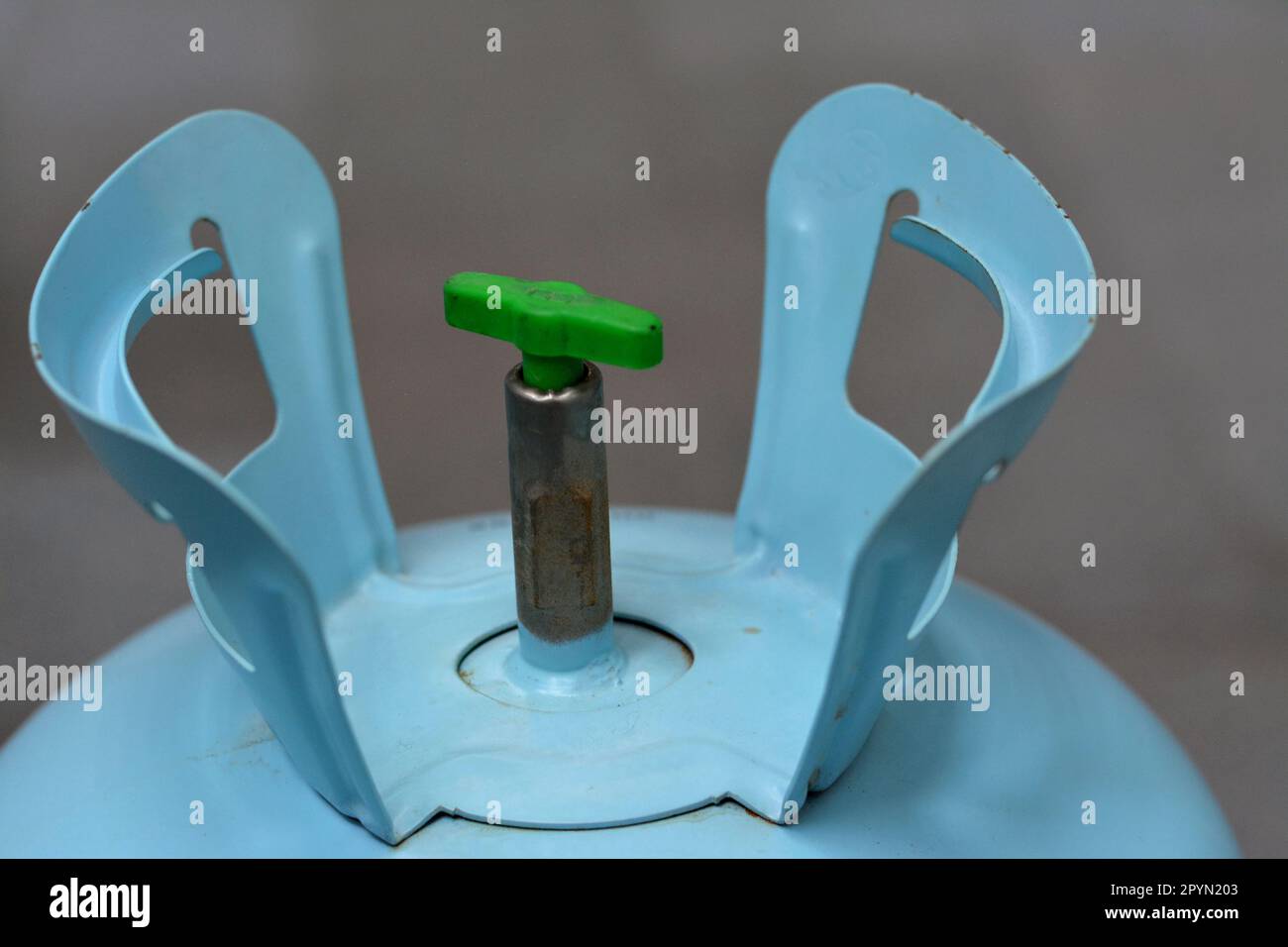 A Freon gas cylinder filled with colorless gas at room temperature ...