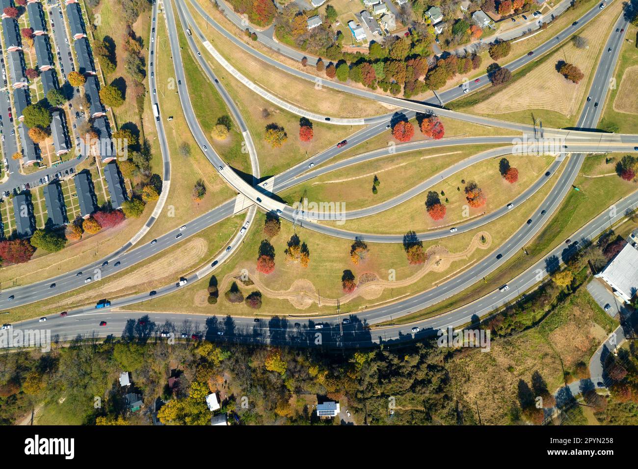 American freeway intersection with fast driving cars and trucks. View ...