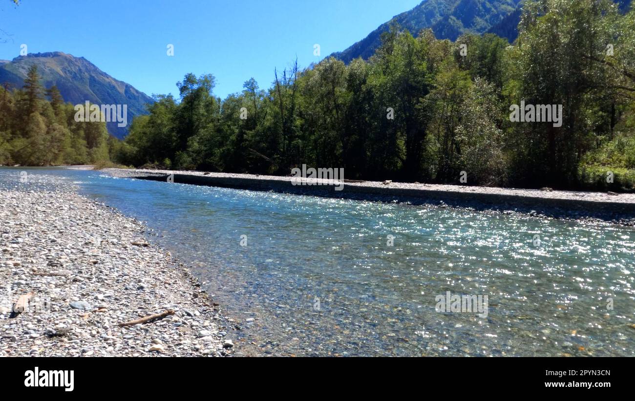 tiny clear cold river with shingle rocks in Arkhyz mountain ridge ...
