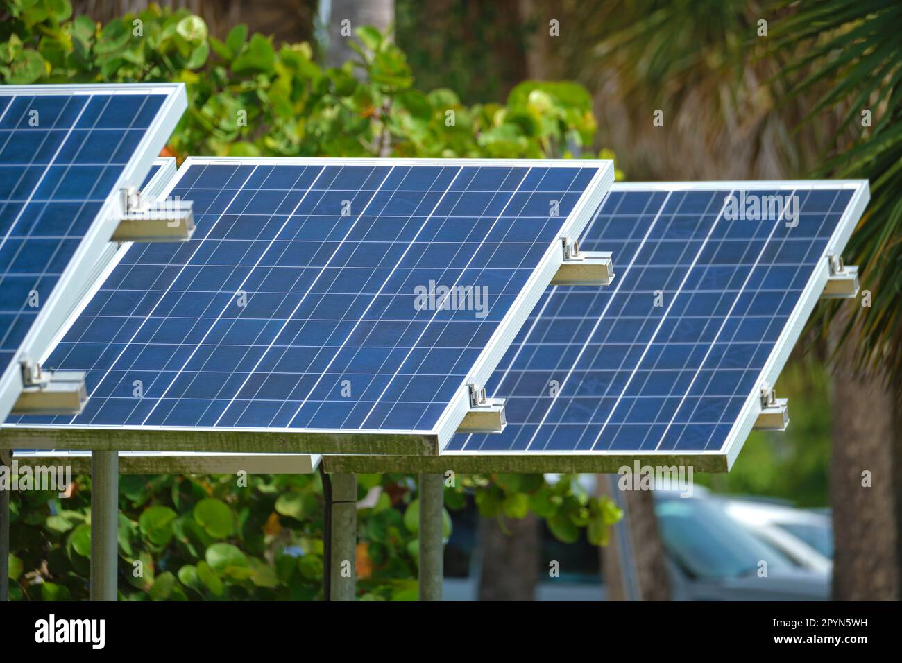 Solar panels installed on stand frame near parking lot for effective ...