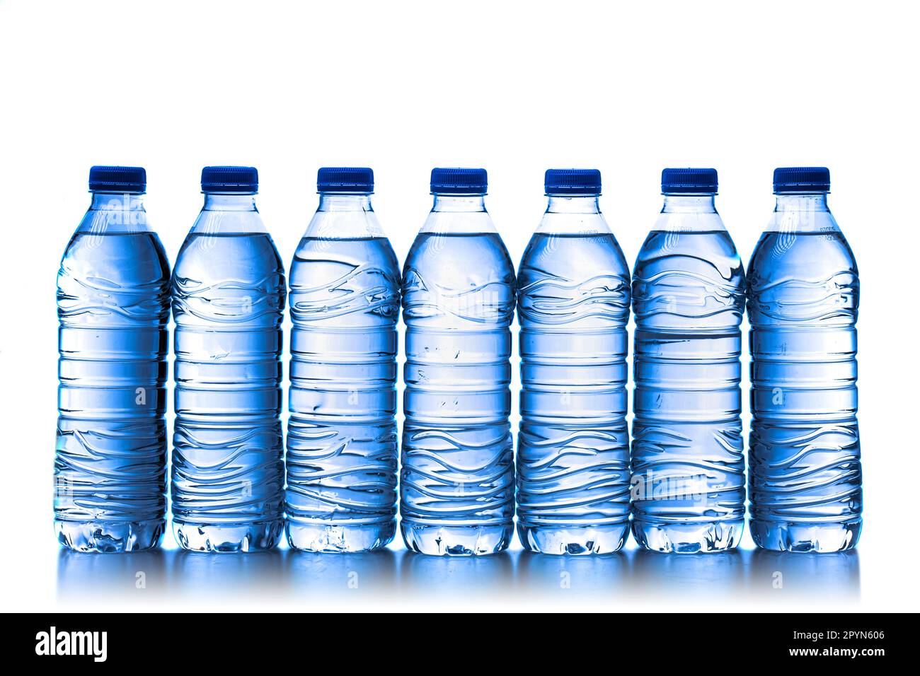 pile of half litre plastic water bottles with blue cap Stock Photo - Alamy