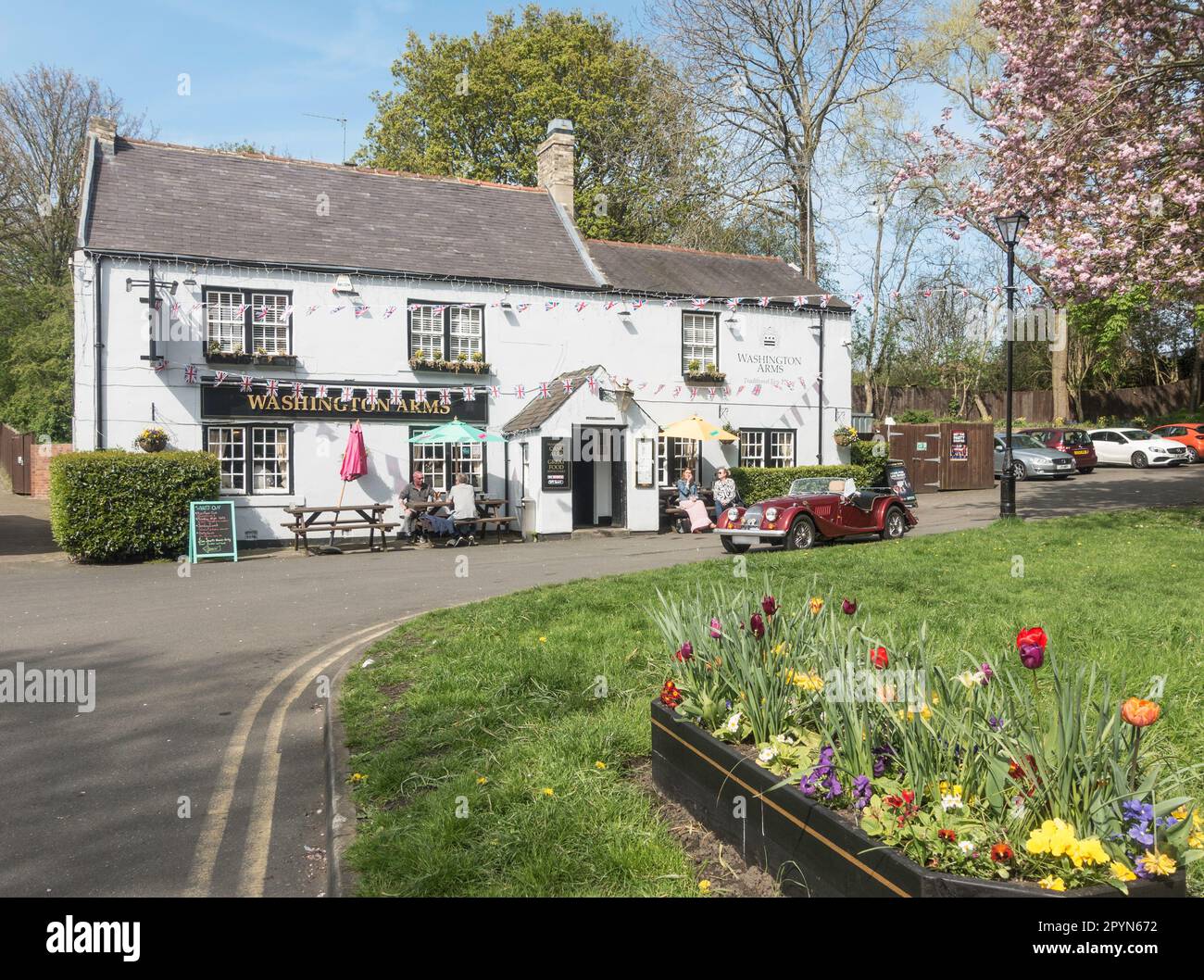 People sitting outside the Washington Arms pub in Washington Village ...
