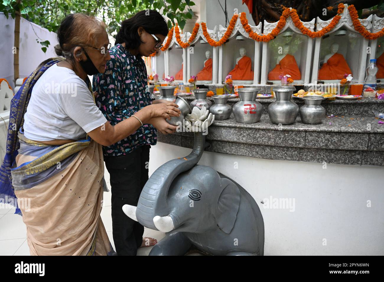 Buddhist devotee offers prayers at a temple during the Buddha Purnima ...