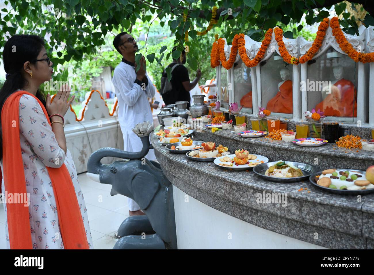 Buddhist devotee offers prayers at a temple during the Buddha Purnima ...
