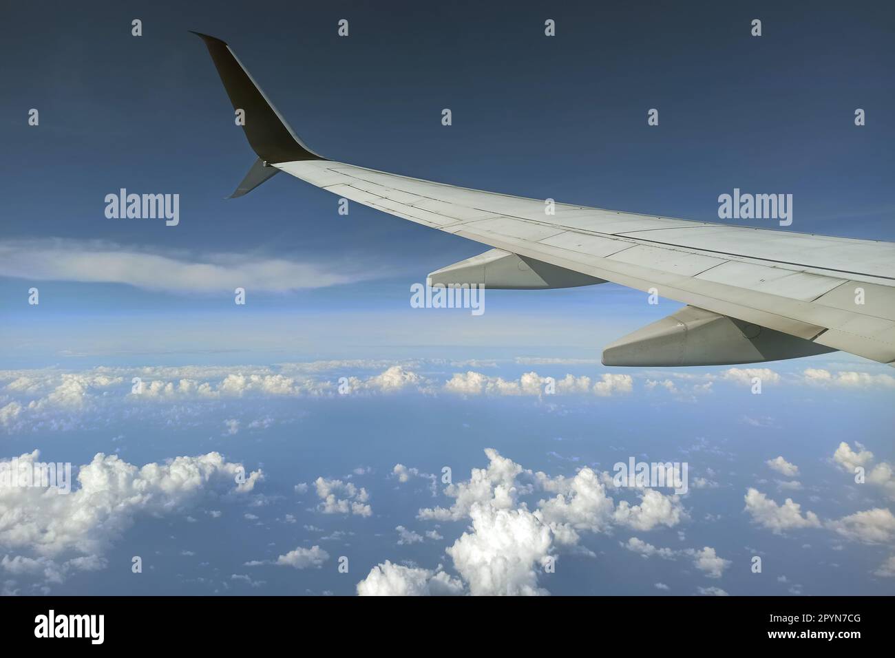View through airplane window of commercial jet plane wing flying high ...