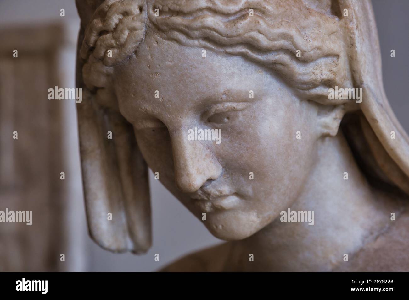 Close up of the face of a statue of a sad girl at the archaeological ...