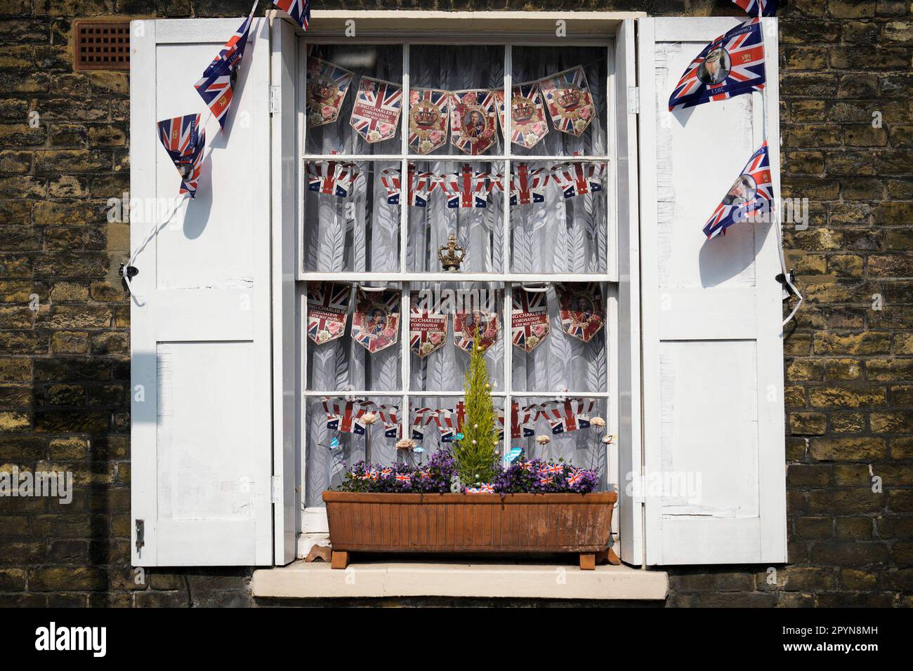 A window is decorated with pennants to celebrate the coronation of King ...