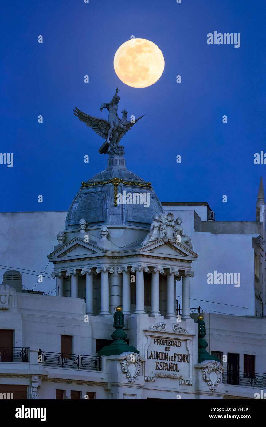 Moon behind La Union y el Fenix statue in Valencia Stock Photo - Alamy