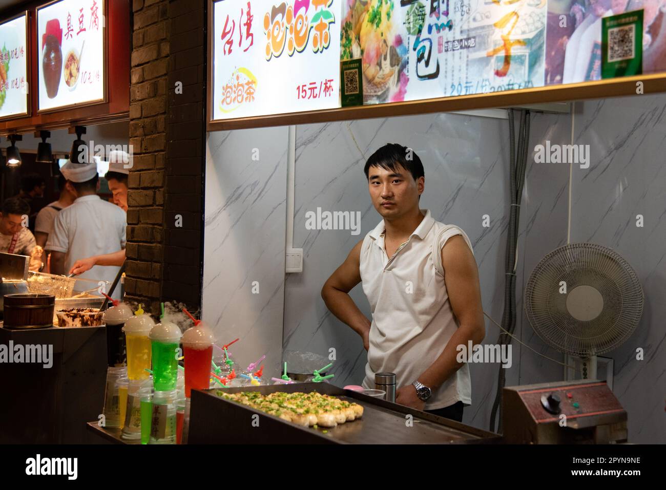 Chinese chef cooking traditional on the snack street in Beijing China ...