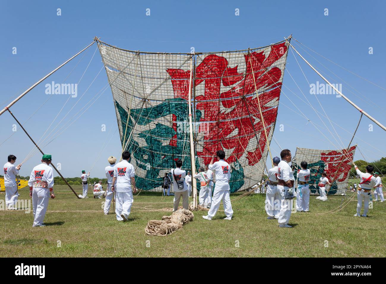 Festival supporters prepare a large kite for flying at the Sagami Giant ...