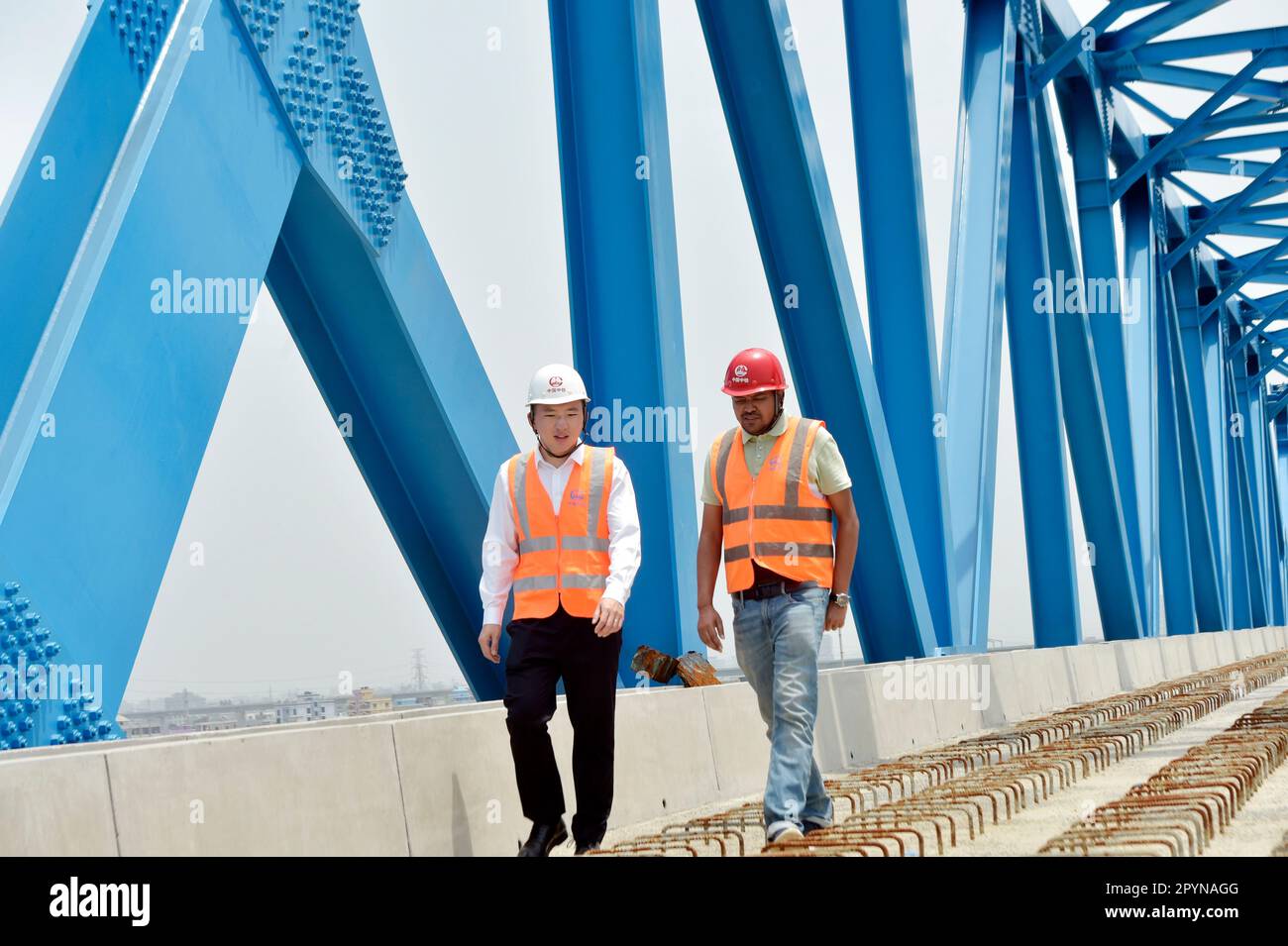 Dhaka. 4th May, 2023. Zhang Yadong (L), an engineer from China Railway Group Limited, works with ...