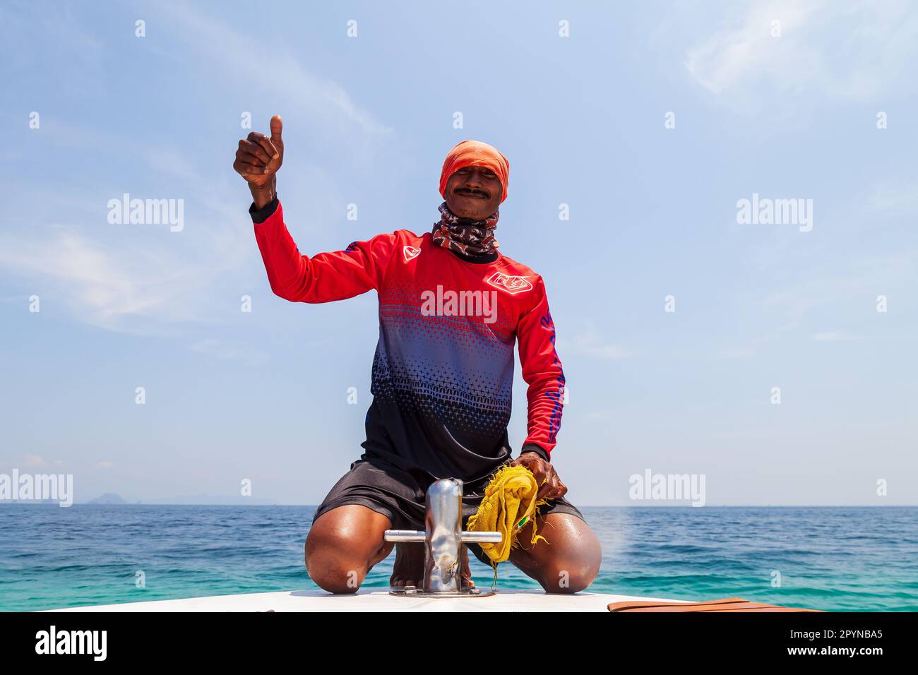 Thailand, Phuket - 01.04.23: A sailor on a speedboat manages the ...
