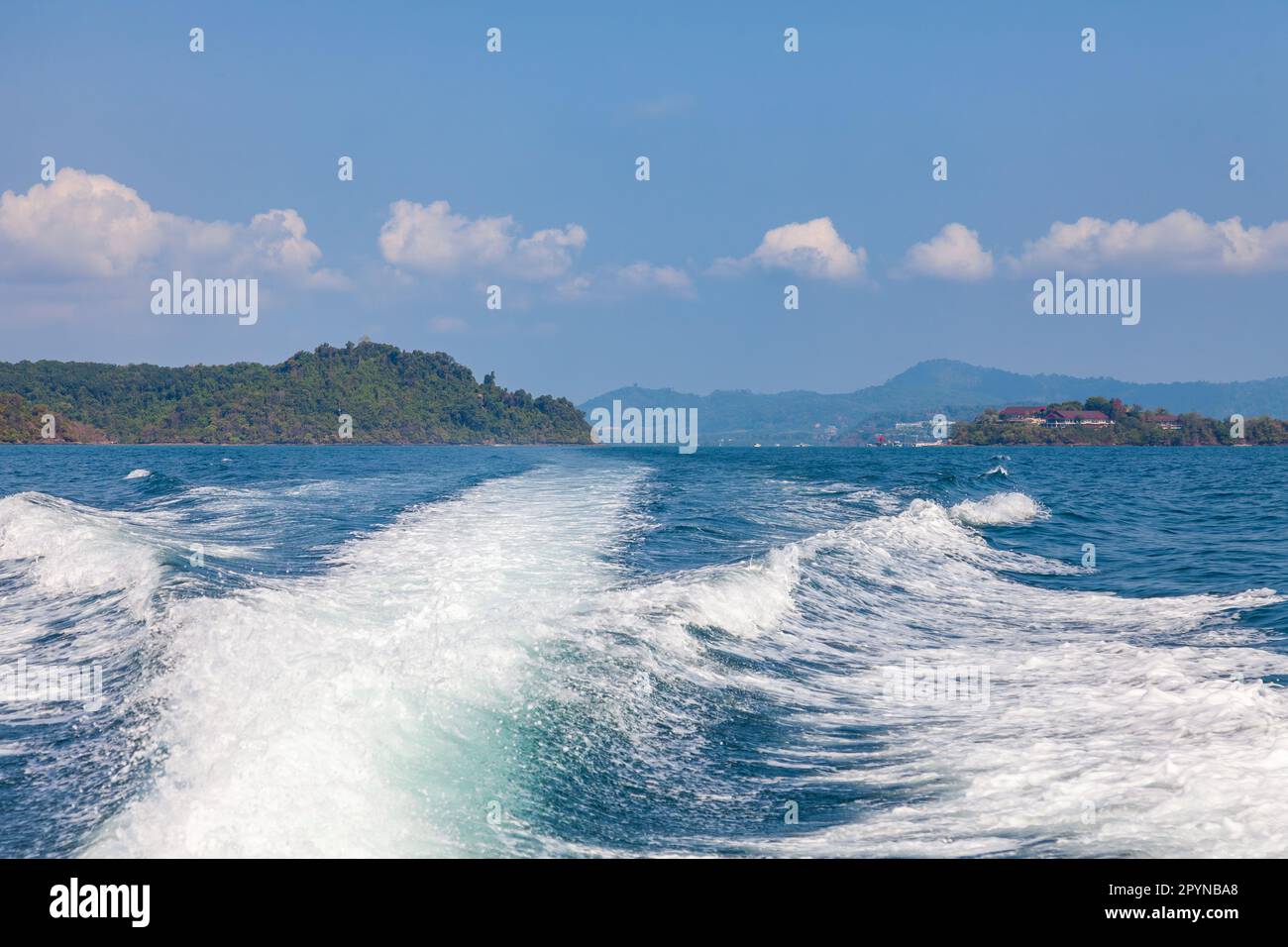 Waves from a speedboat on the blue sea with splashes and a trail from a ...