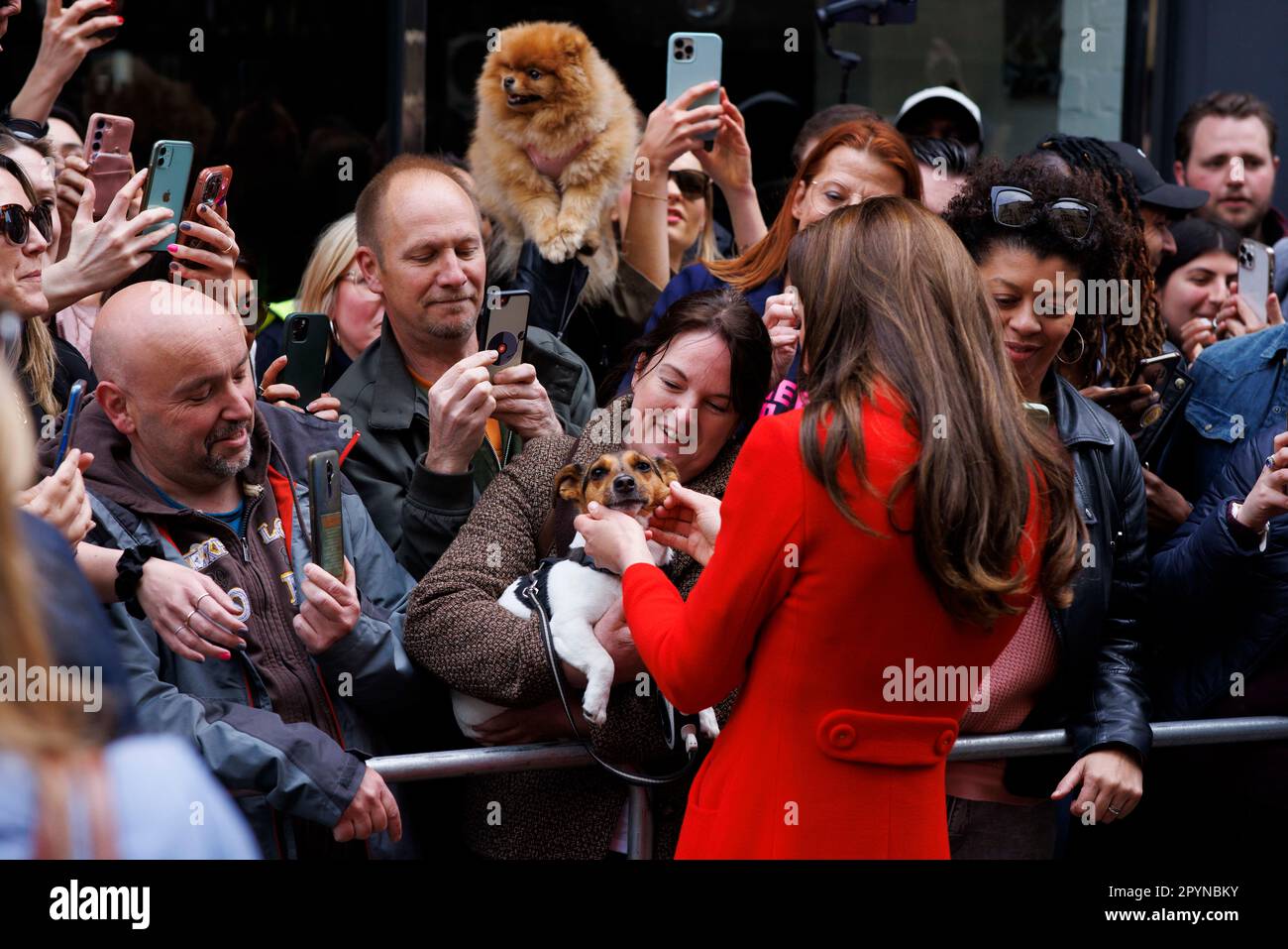 Catherine, Princess of Wales plays with a royal fan’s dog during a ...
