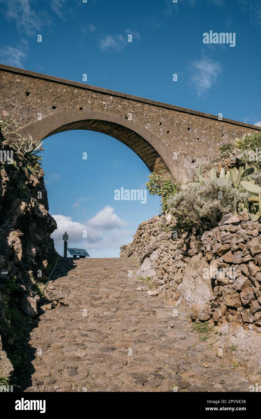 An old stone road with a big arch on top of it Stock Photo - Alamy