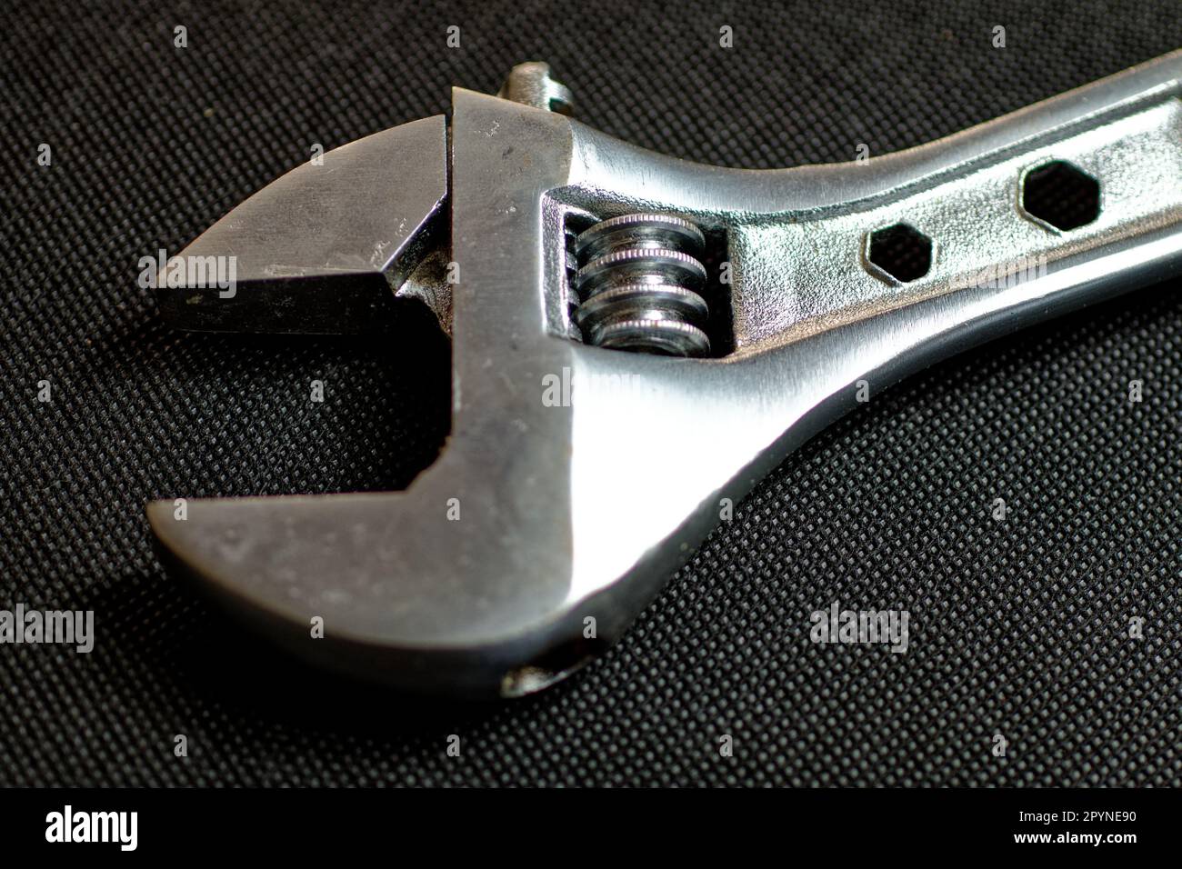Tools, handcraft, do-it-yourself: Wrench, cropped against dark ...