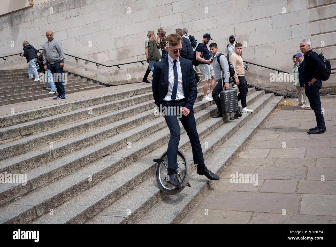 A young man falls off his unicycle, on steps on the Mall, on 4th May ...