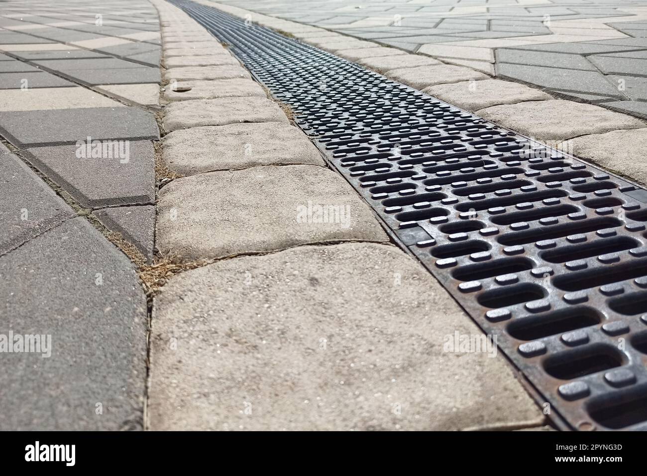 Sewer drain grate on the sidewalk close up Stock Photo - Alamy