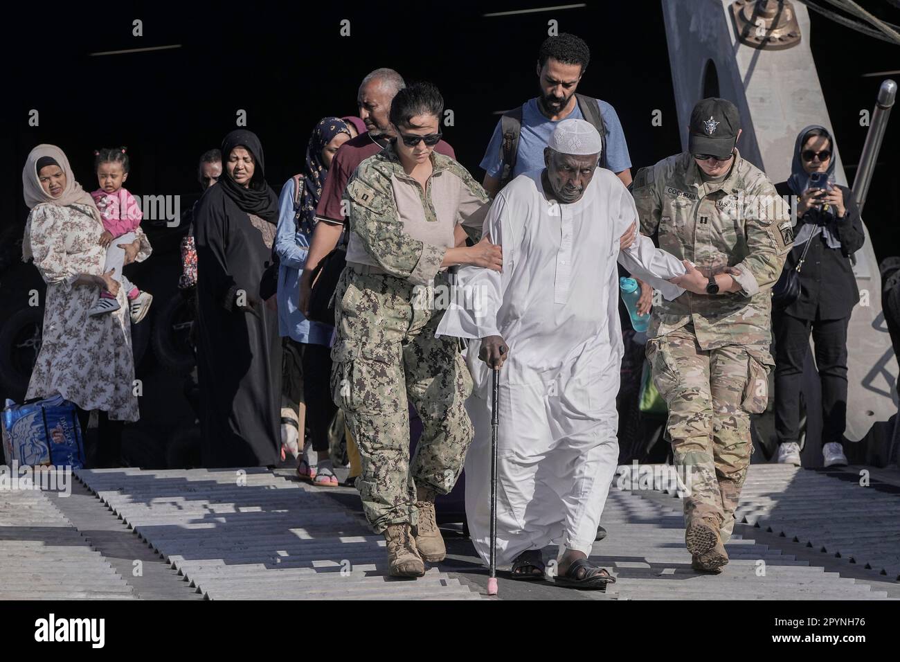 Sudanese evacuee, Mohammed Abdel Rahman, 78, is helped by US naval ...