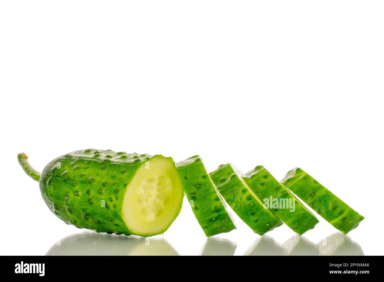 One ripe cucumber gherkin cut into slices, macro, isolated on white ...