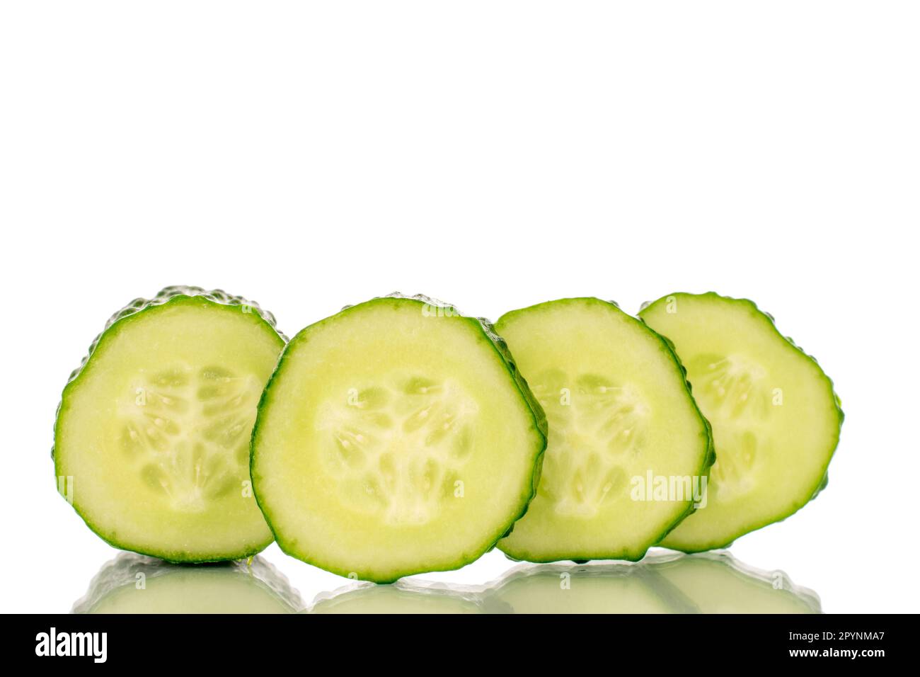 One ripe cucumber gherkin cut into slices, macro, isolated on white ...