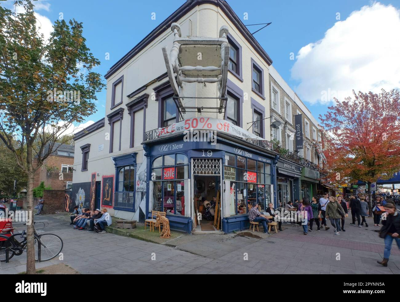 A large rocking chair on the front facade of Old and New furniture ...